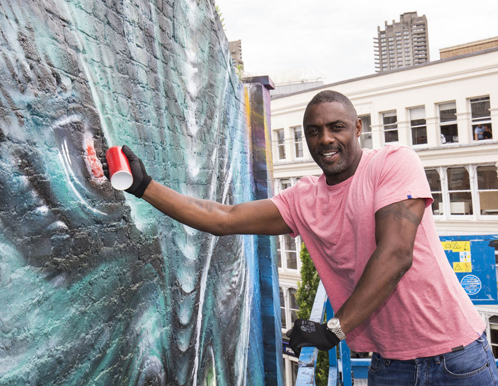 Idris Elba presented with tank top referencing Tom Hiddleston's I heart ...
