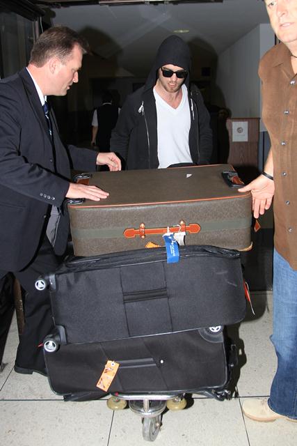 Robert Pattinson has a lot of baggage at LAX