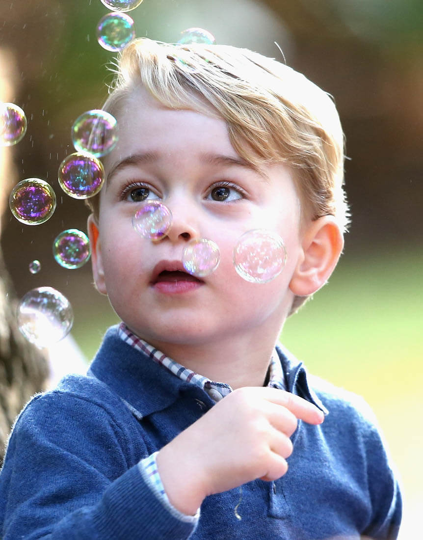 Prince George loves the bubble maker and Princess Charlotte sits on a ...